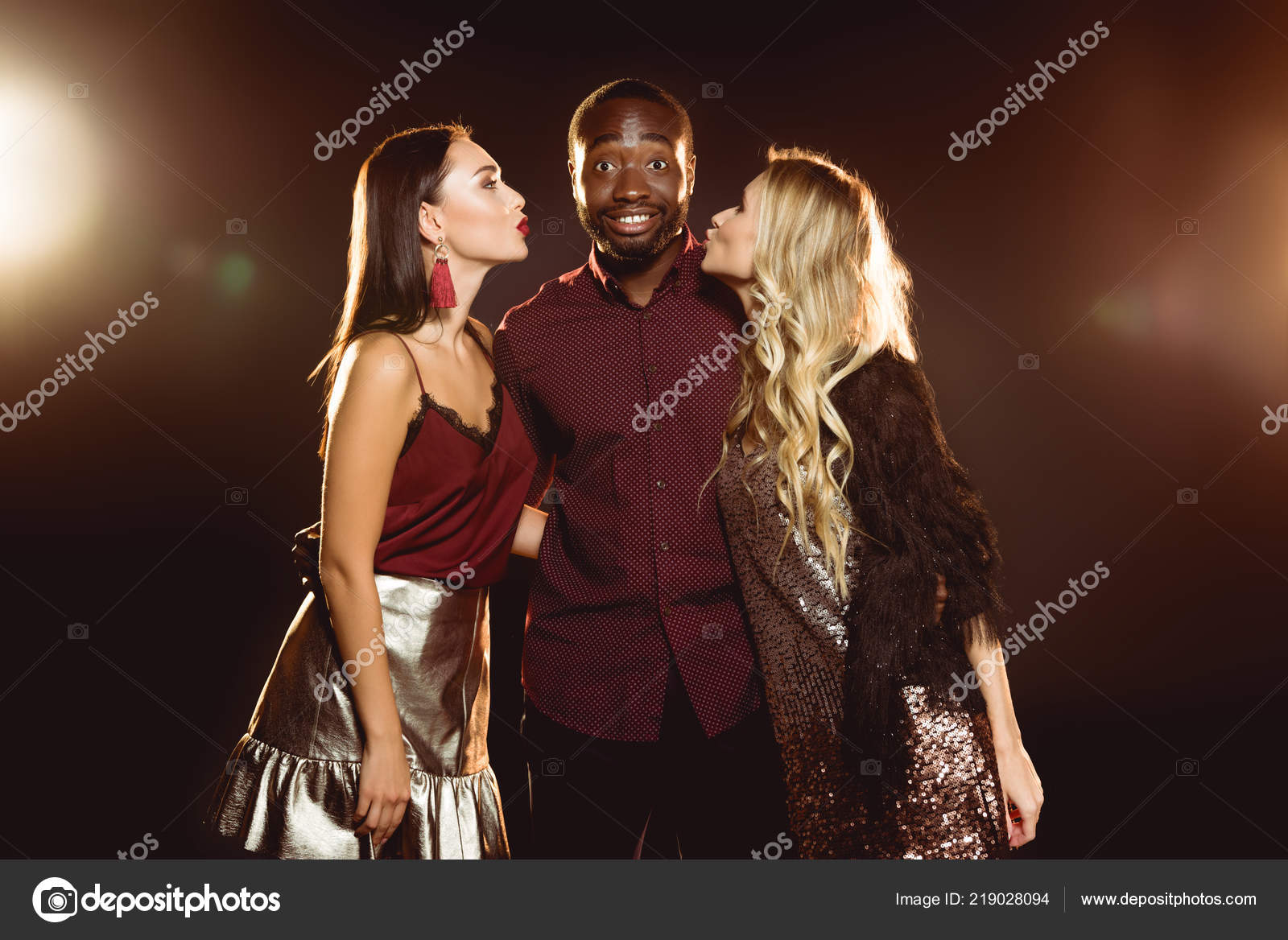Surprised African American Man Hugging Two Attractive Women While
