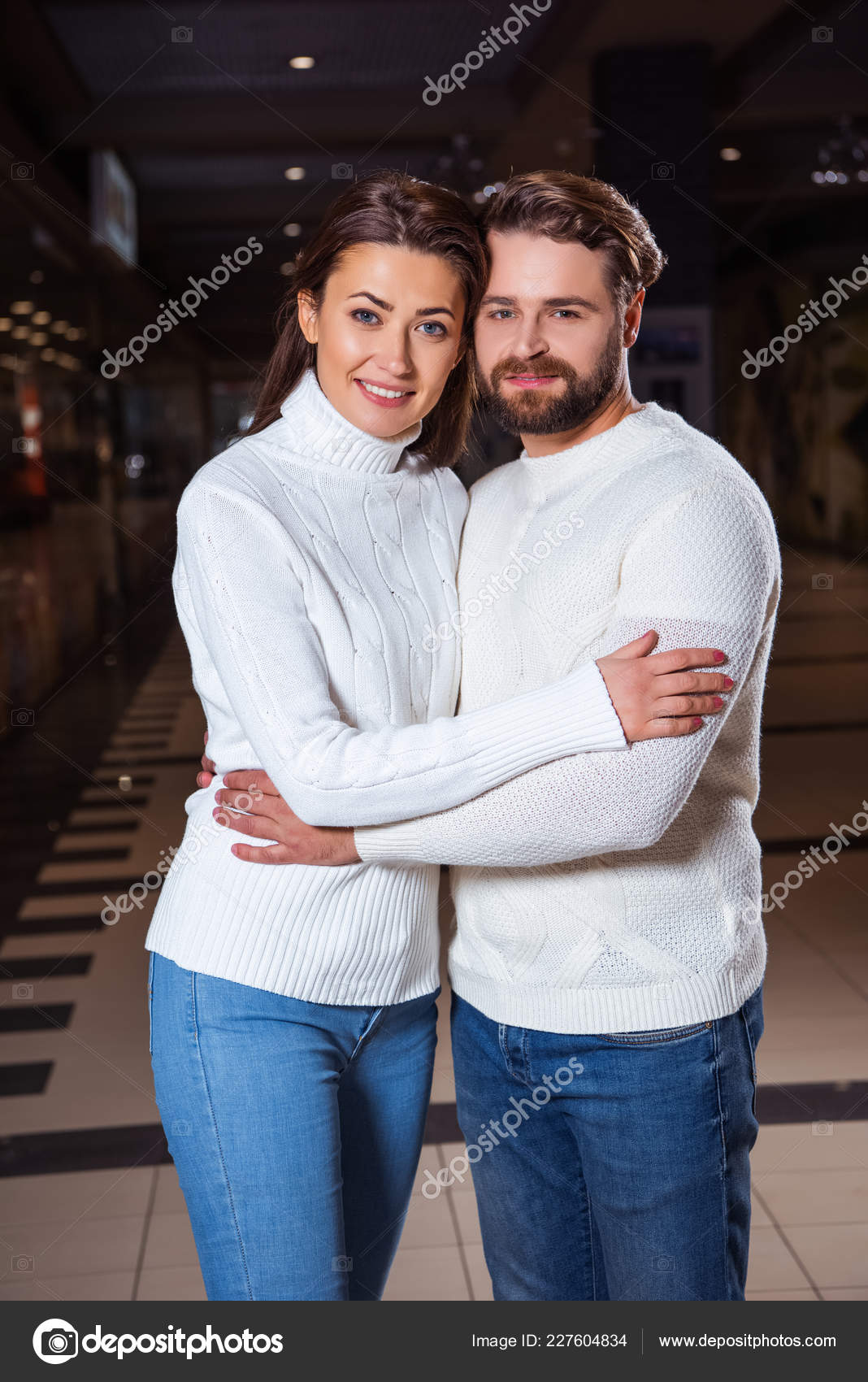 Smiling Couple White Sweaters Hugging Looking Camera Stock Photo by ...