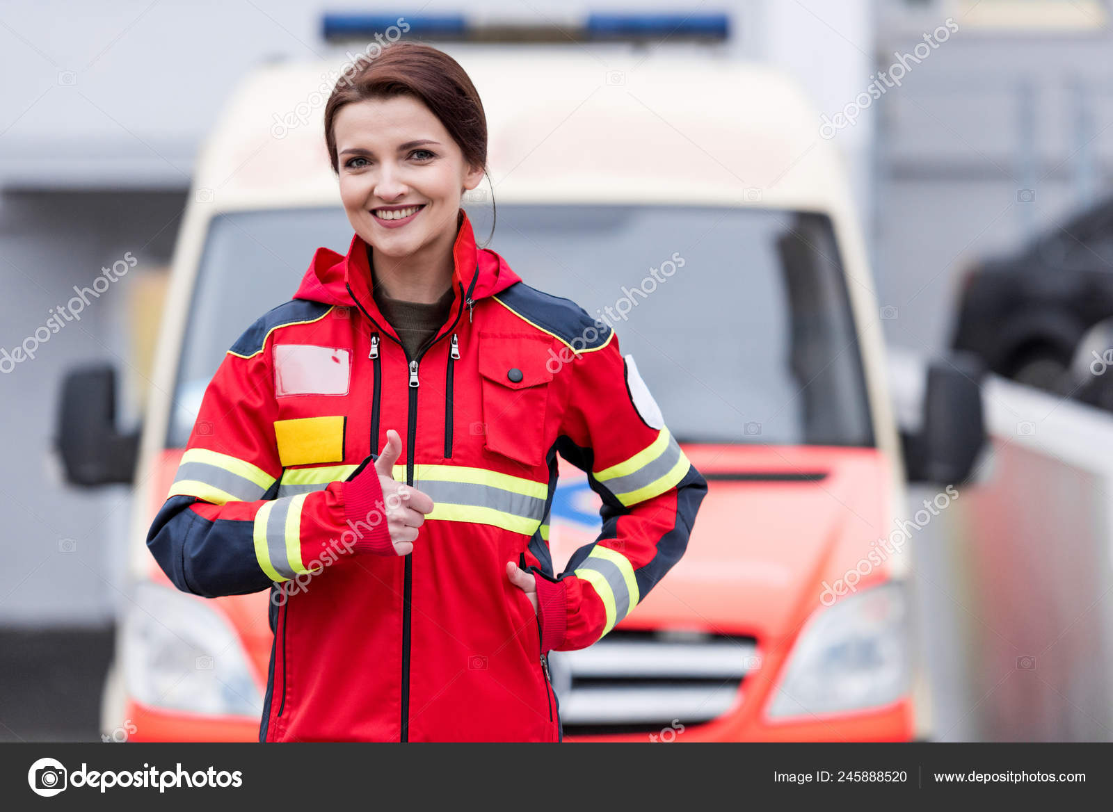 Charming Female Paramedic Red Uniform Showing Thumb — Stock Photo ...