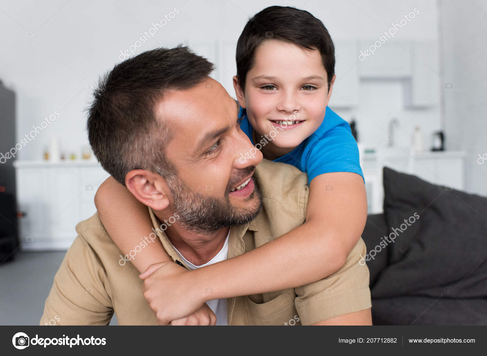 Portrait Smiling Boy Hugging Father Looking Camera Home ⬇ Stock Photo ...