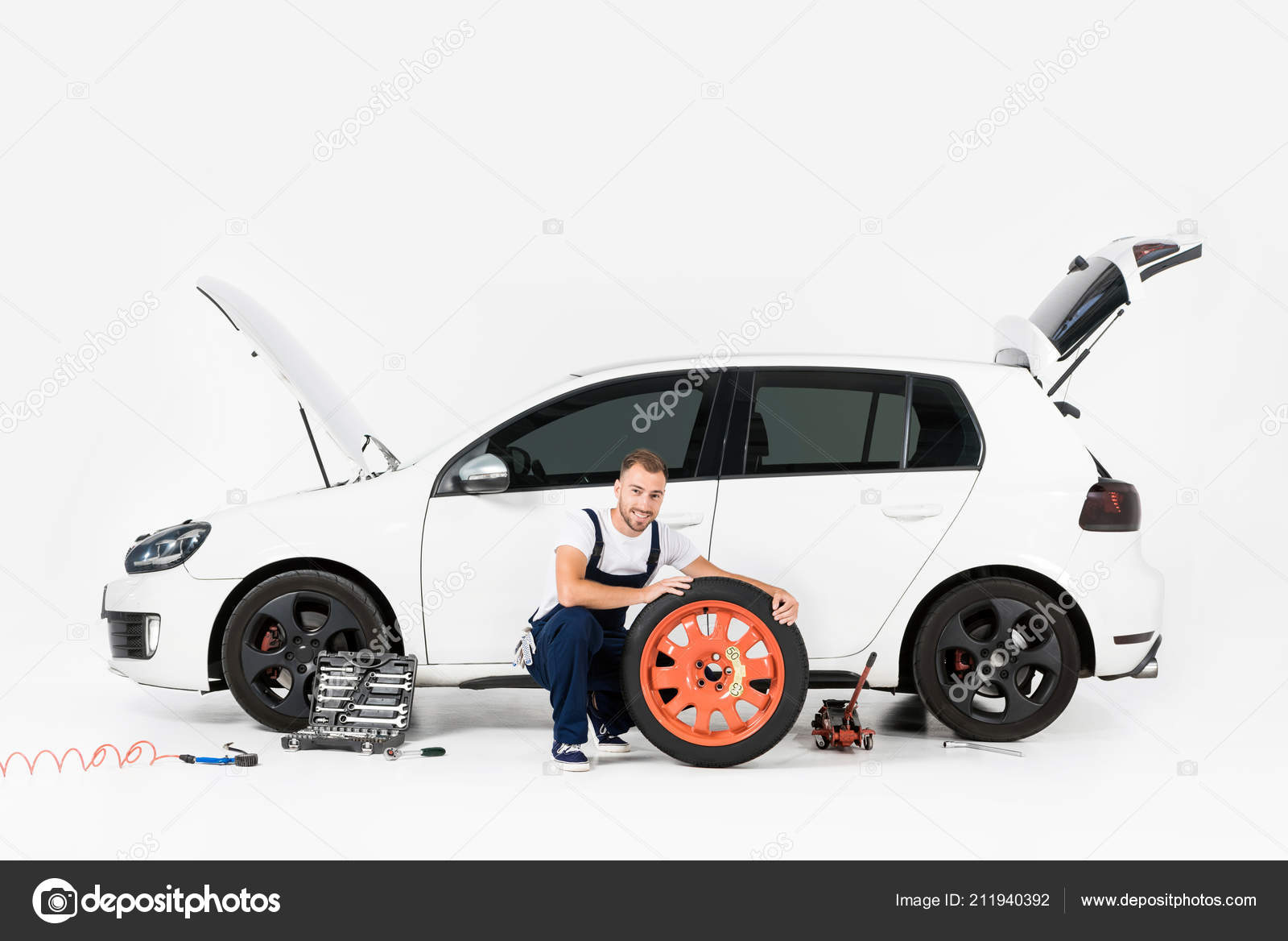 Smiling Auto Mechanic Changing Car Tire Looking Camera White Stock ...