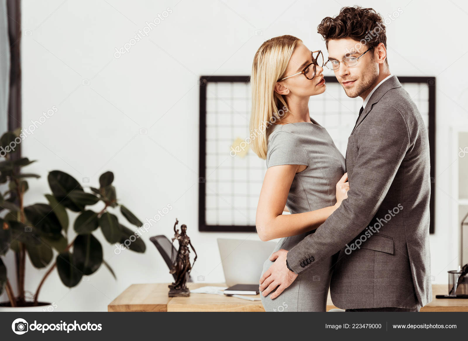 Young Lawyers Hugging Each Other While Standing Office Flirt Office ...
