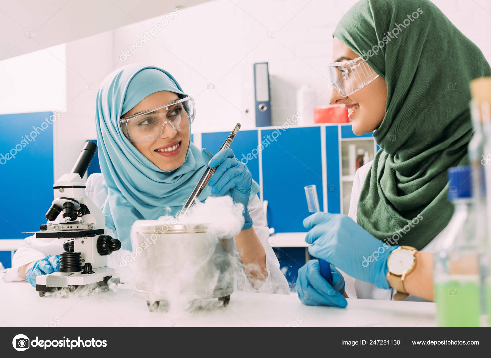 Smiling Female Muslim Scientists Experimenting Microscope Dry Ice ...