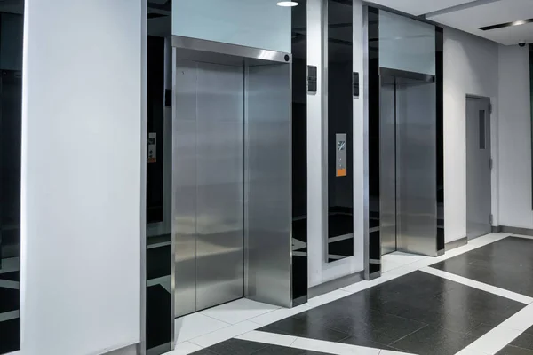 Modern steel elevator cabins in a business lobby or Hotel, Store ...