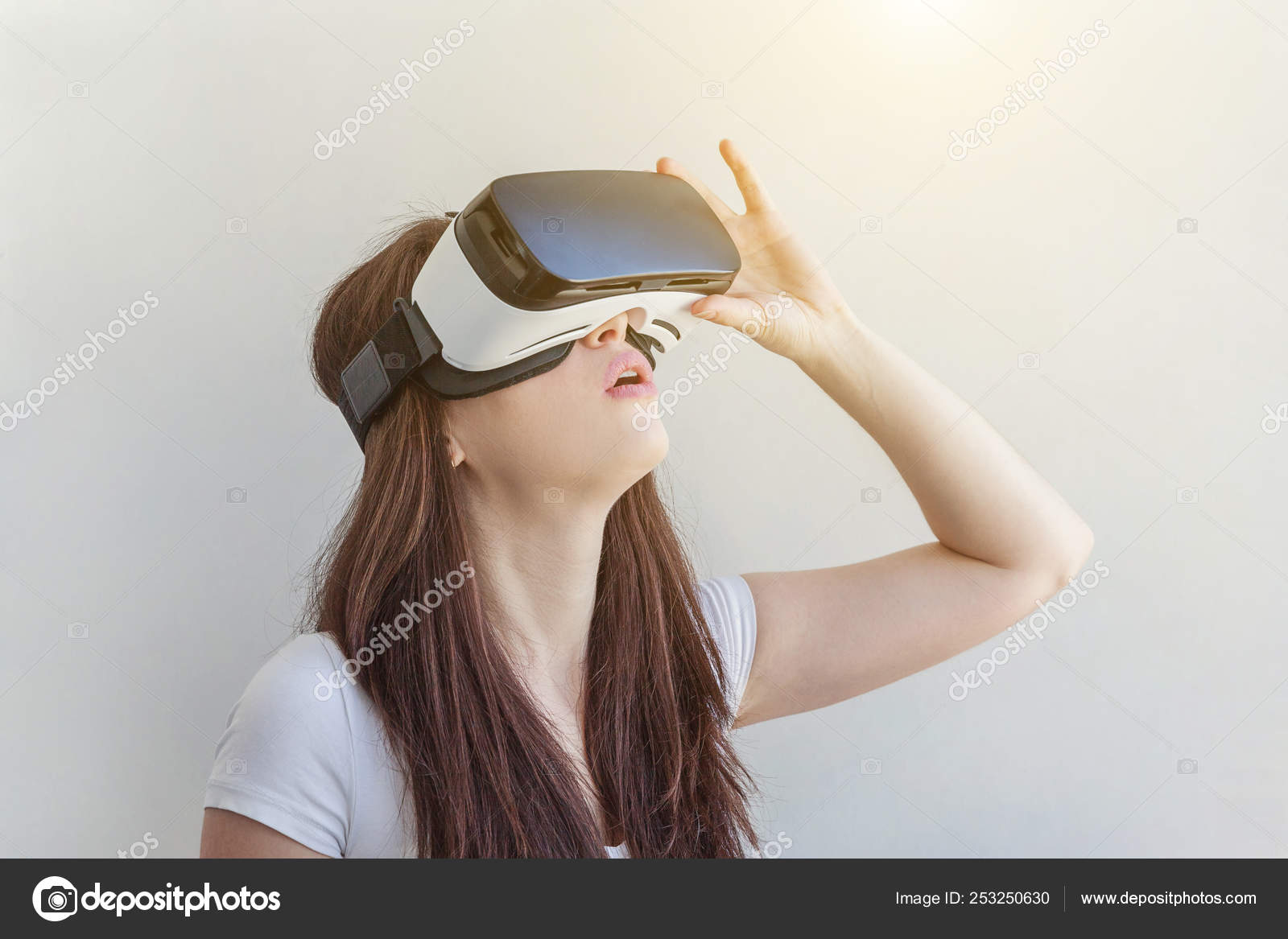 Smile young woman wearing using virtual reality VR glasses helmet ...