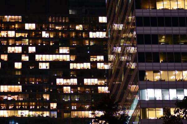 Office building at night. Late night at work. Glass curtain wall office ...