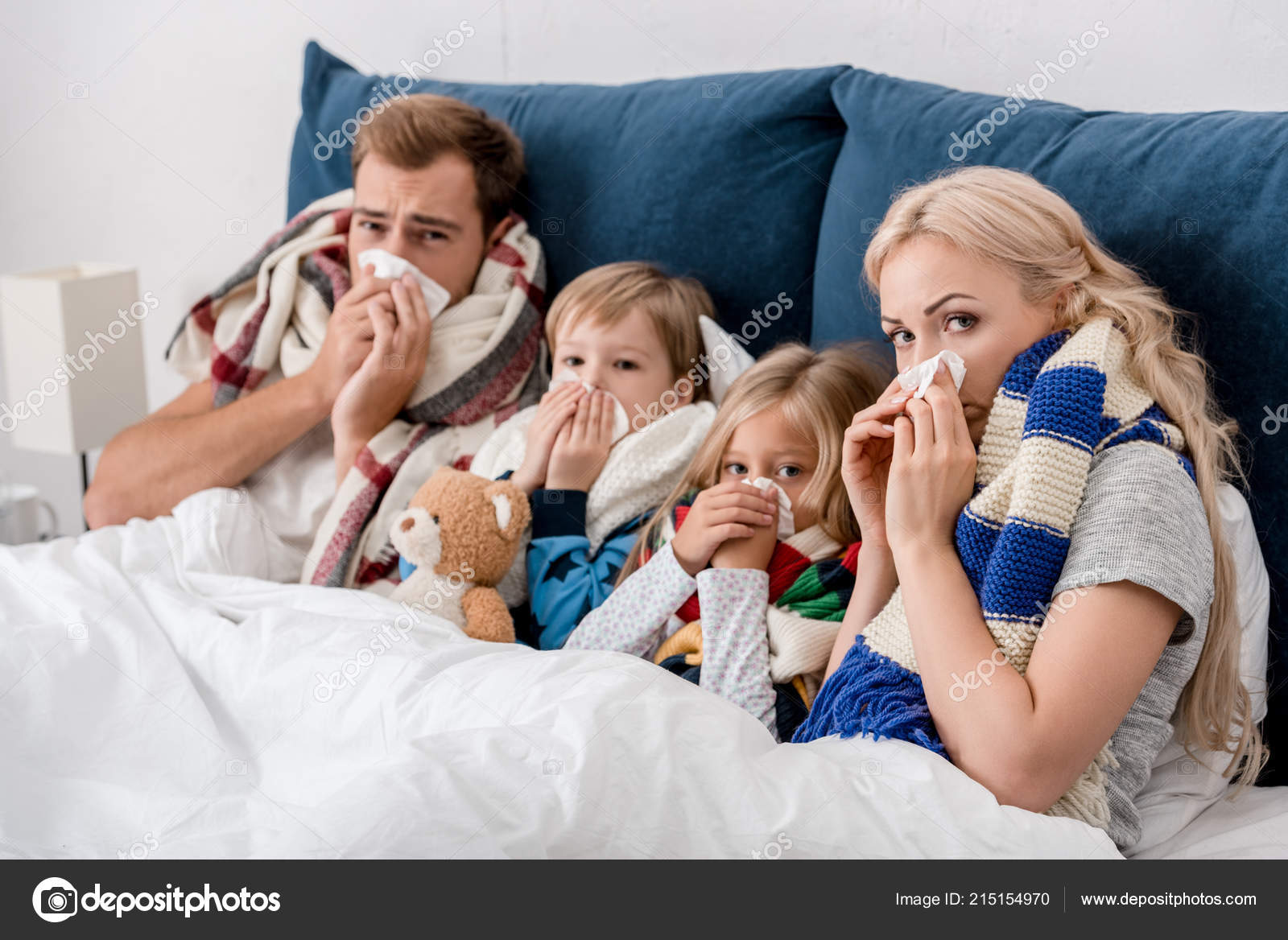 Sick Young Family Lying Bed — Stock Photo © AndrewLozovyi #215154970