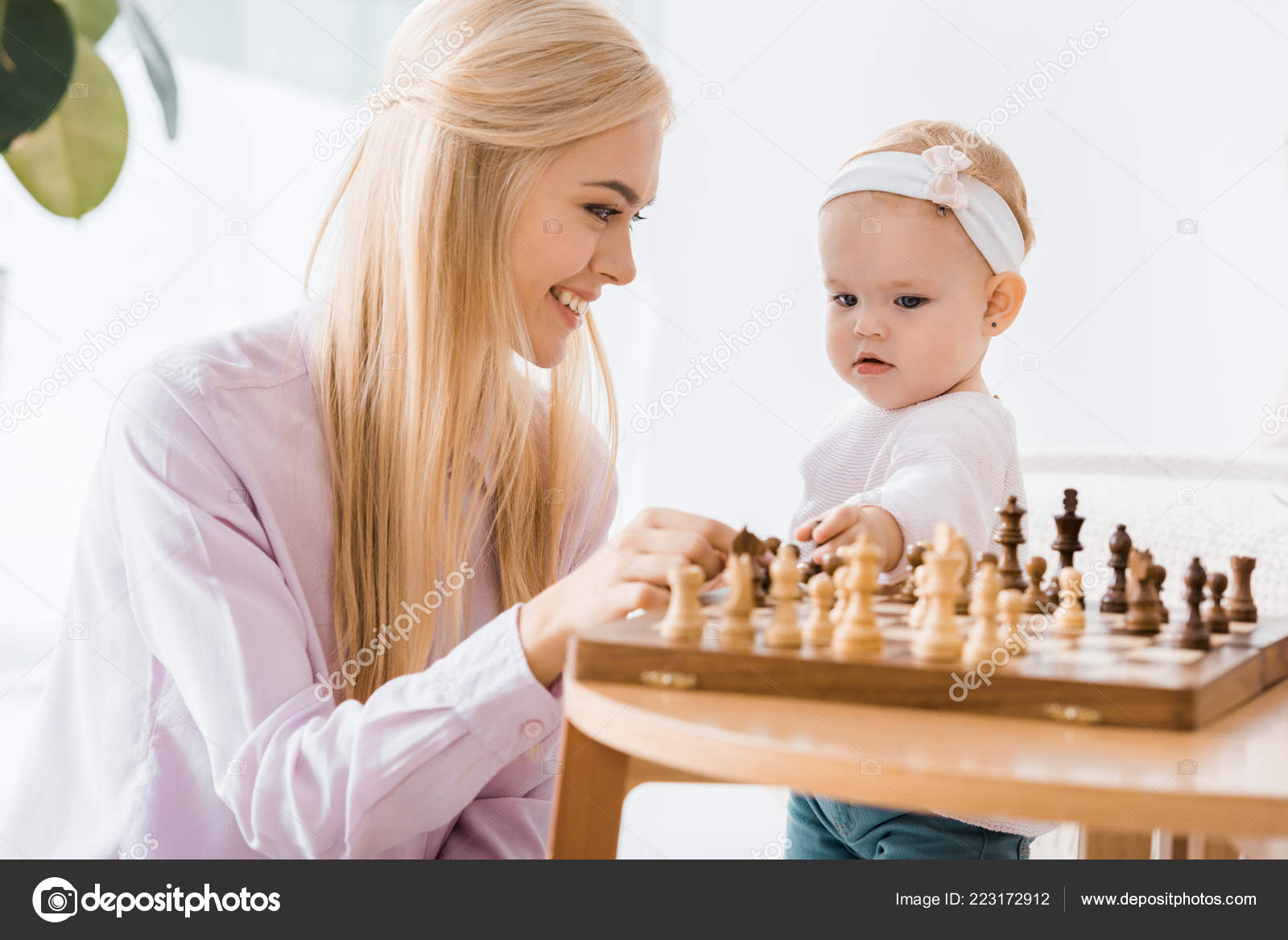 Young Cheerful Mother Teaching Daughter Playing Chess Stock Photo by ...