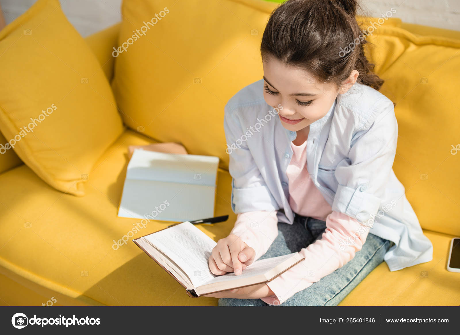 Cute Smiling Child Reading Book While Sitting Yellow Sofa Home — Stock ...