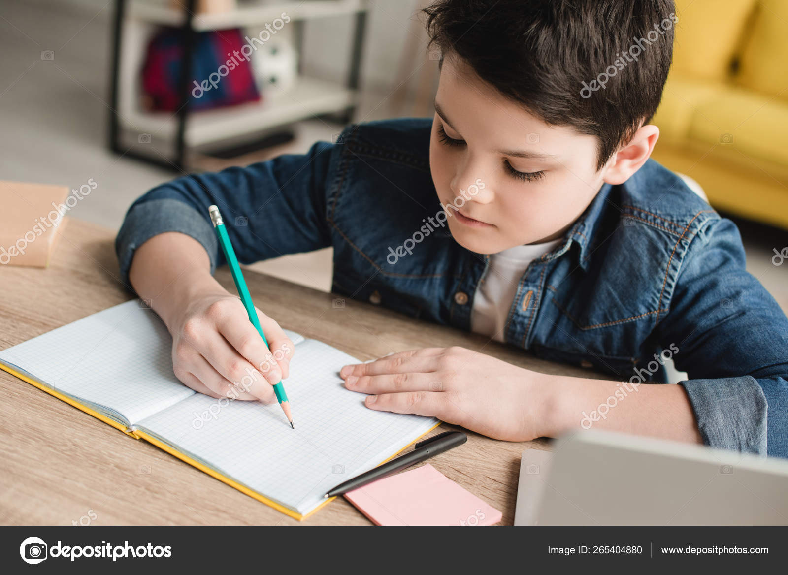 Cute Attentive Boy Writing Notebook While Sitting Desk Doing Homework ...