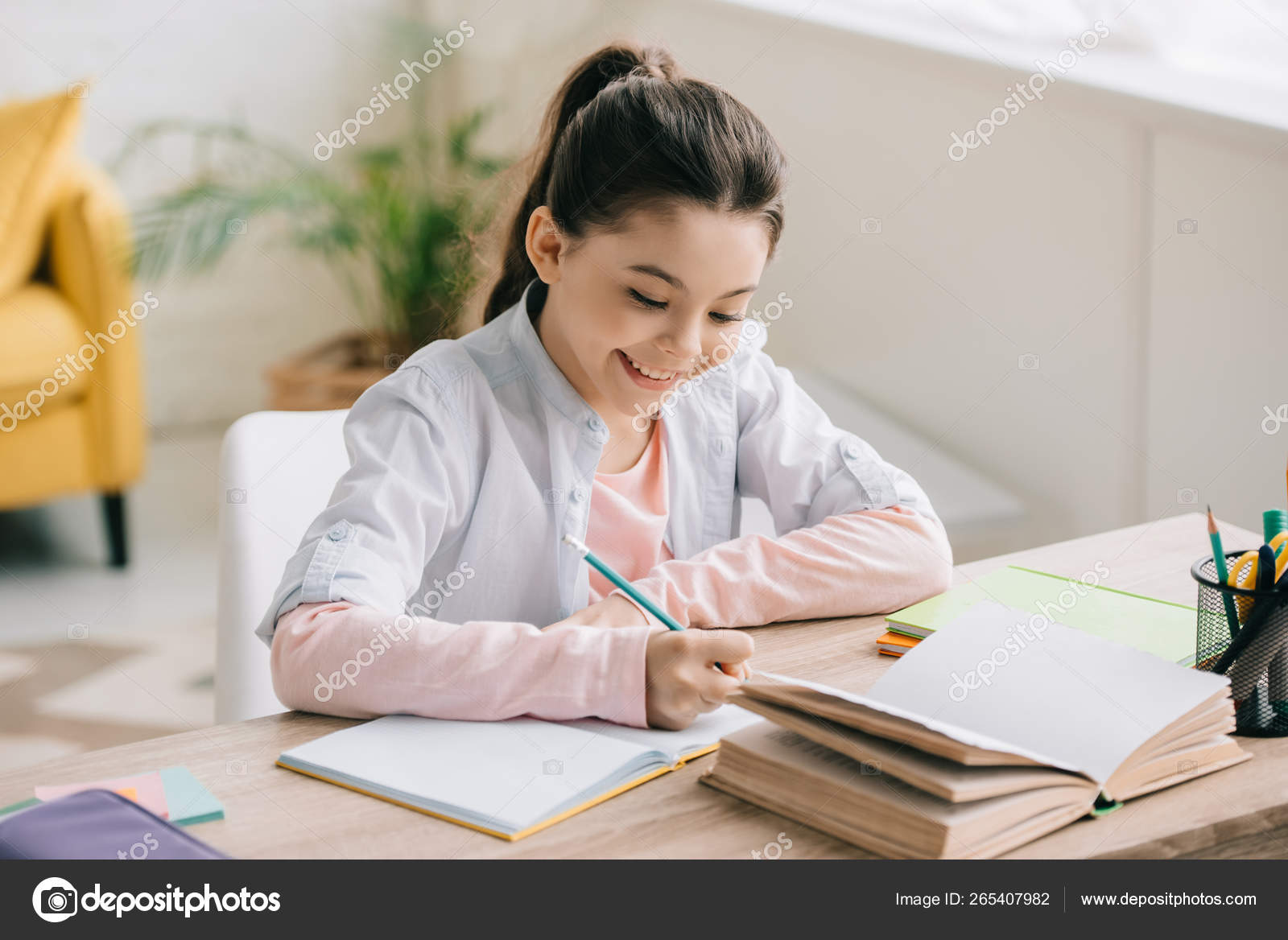 Adorable Cheerful Child Writing Notebook While Sitting Desk Book Doing ...