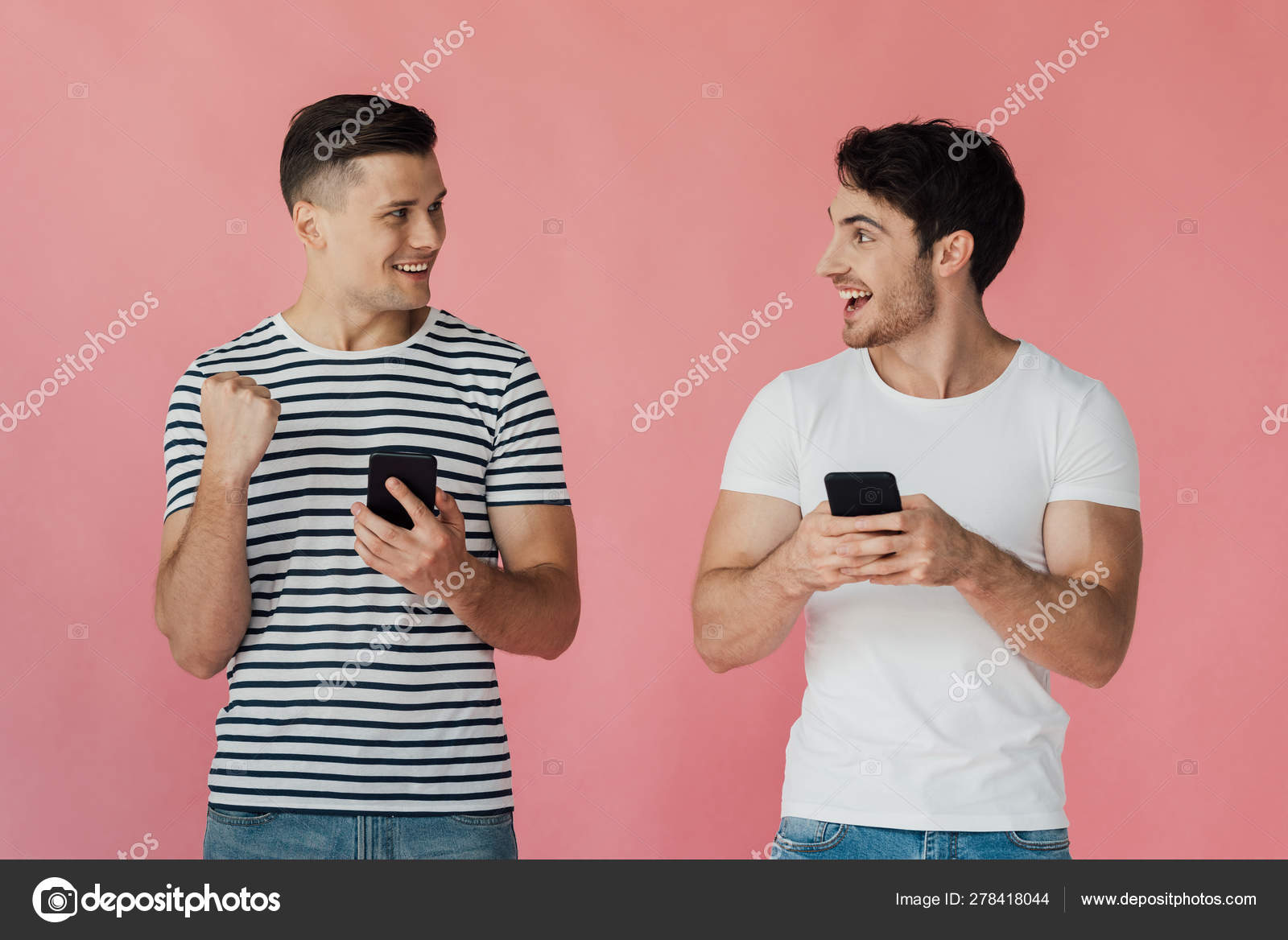Two Smiling Men Using Smartphones Looking Each Other Isolated Pink ...