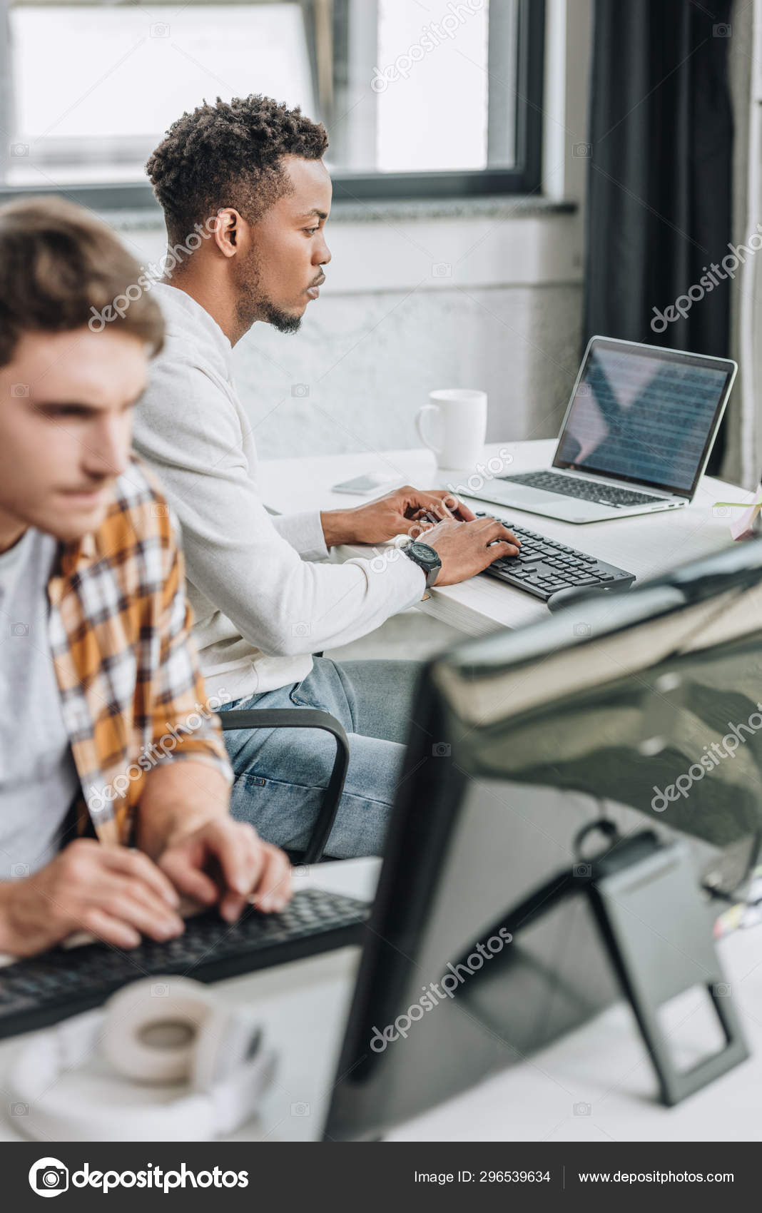 Selective Focus Two Young Multicultural Programmers Working Together ... Selective Focus Two Young Multicultural Programmers Working Together ...