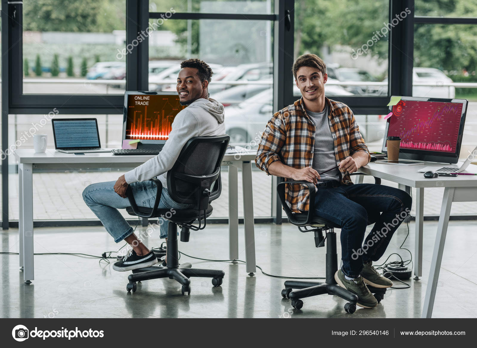Two Cheerful Multicultural Programmers Smiling Camera While Sitting ... Two Cheerful Multicultural Programmers Smiling Camera While Sitting ...
