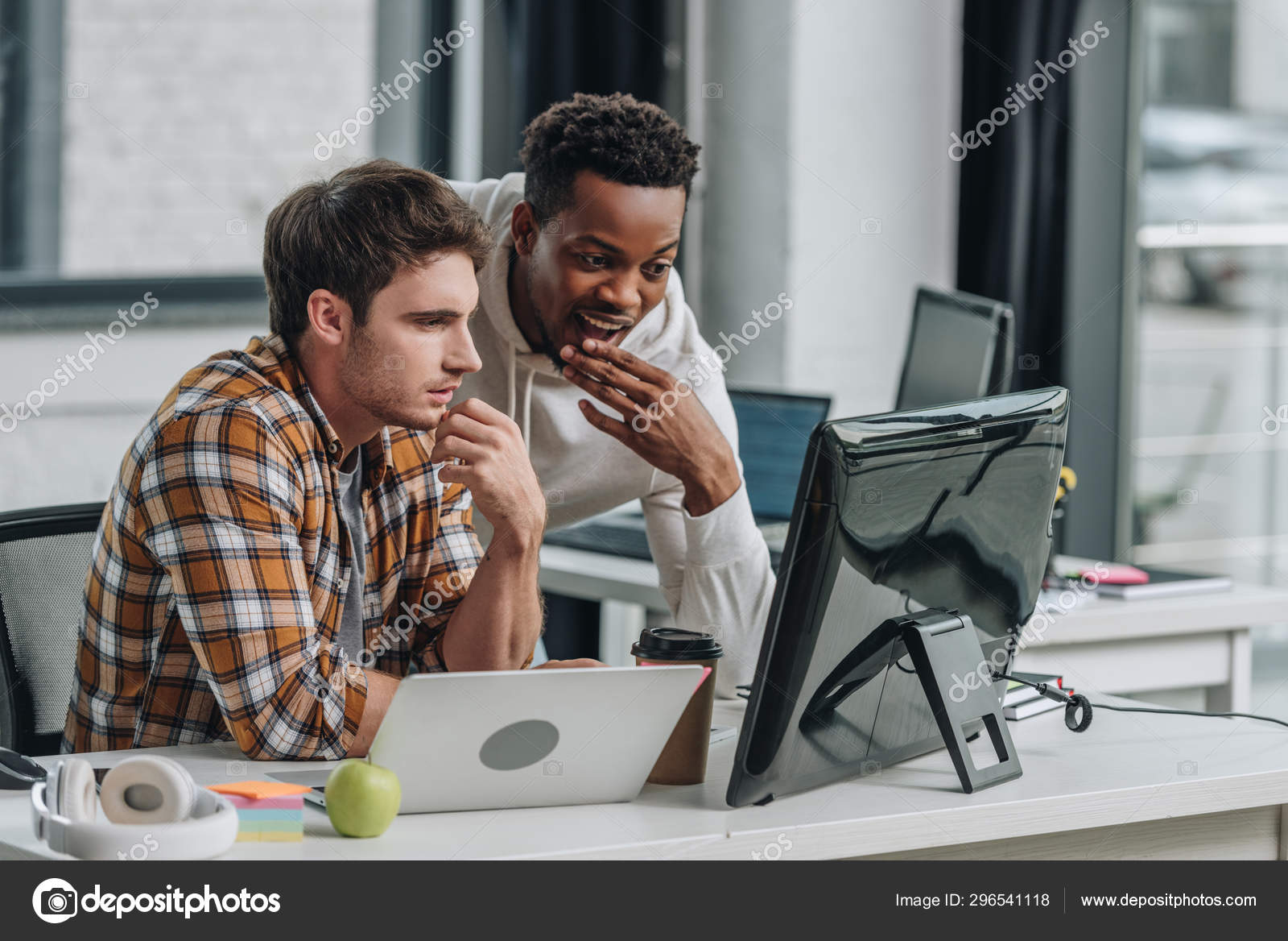 Two Thoughtful Multicultural Programmers Looking Computer Monitor While ... Two Thoughtful Multicultural Programmers Looking Computer Monitor While ...