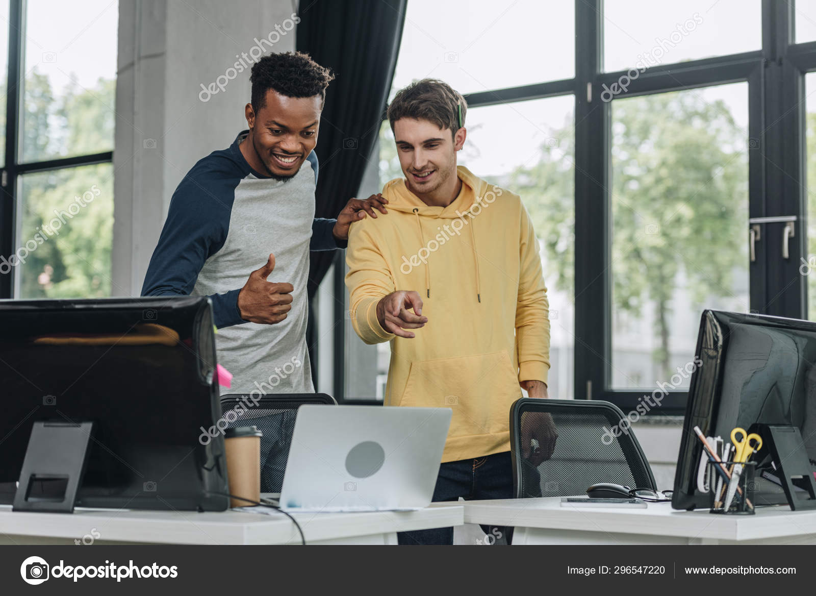 Two Cheerful Multicultural Programmers Looking Laptop Office Stock ... Two Cheerful Multicultural Programmers Looking Laptop Office Stock ...