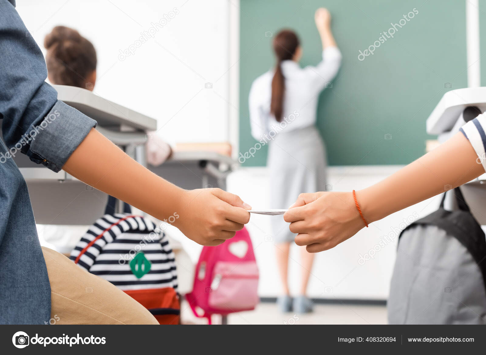 Back View Teacher Writing Chalkboard While Schoolboy Passing Note ...