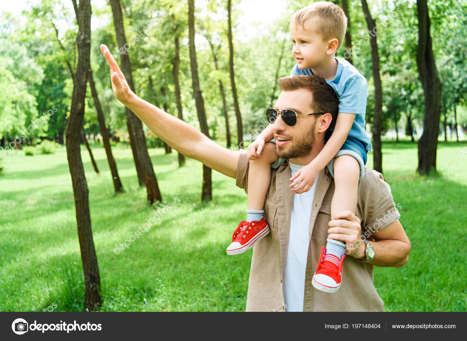 Father Waving Hand Someone Holding Son Shoulders Park — Stock Photo ...