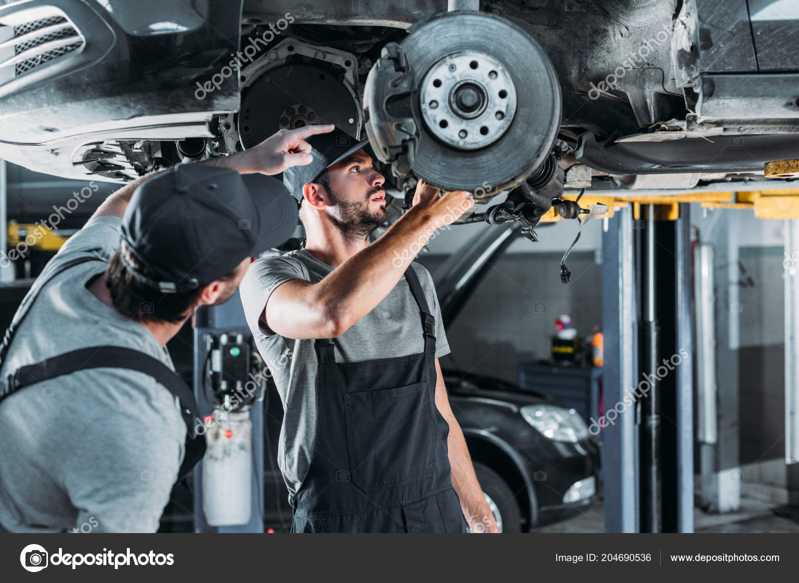 Auto Mechanics Repairing Car Wheel Workshop Stock Photo by ... Auto Mechanics Repairing Car Wheel Workshop Stock Photo by ...