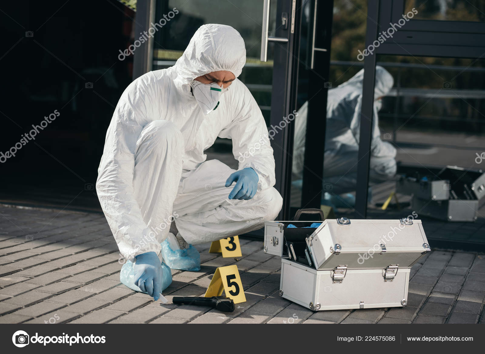 Male Criminologist Protective Suit Latex Gloves Sitting Evidence Gun