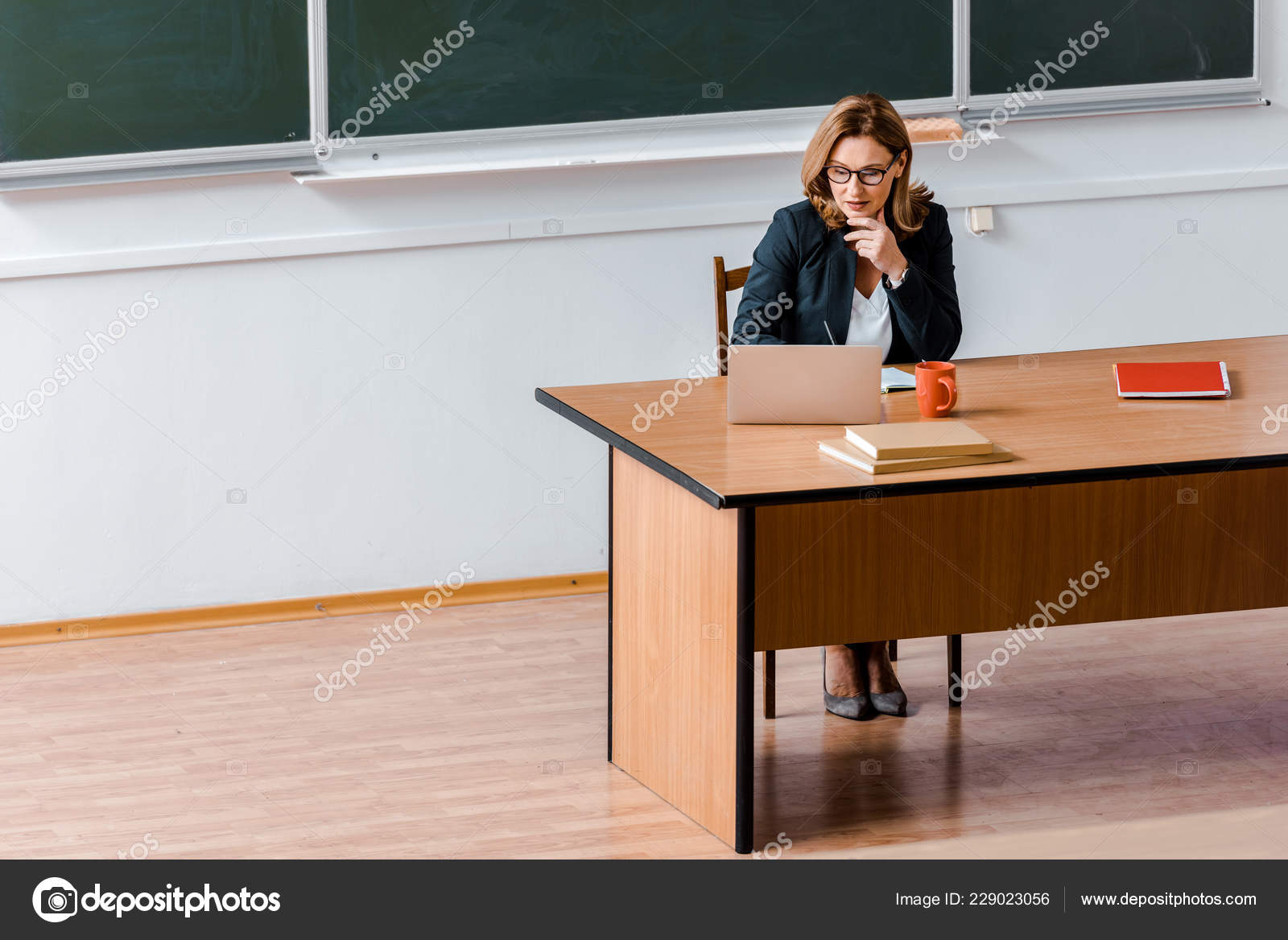 Female University Professor Glasses Sitting Desk Using Laptop Classroom ...
