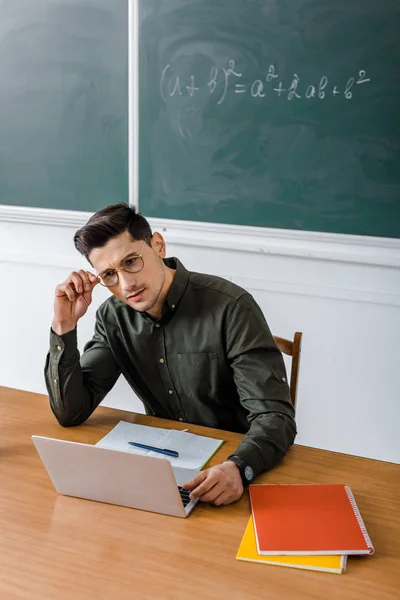 Smiling Male Teacher Formal Wear Looking Camera Standing Desk Classroom ... Smiling Male Teacher Formal Wear Looking Camera Standing Desk Classroom ...