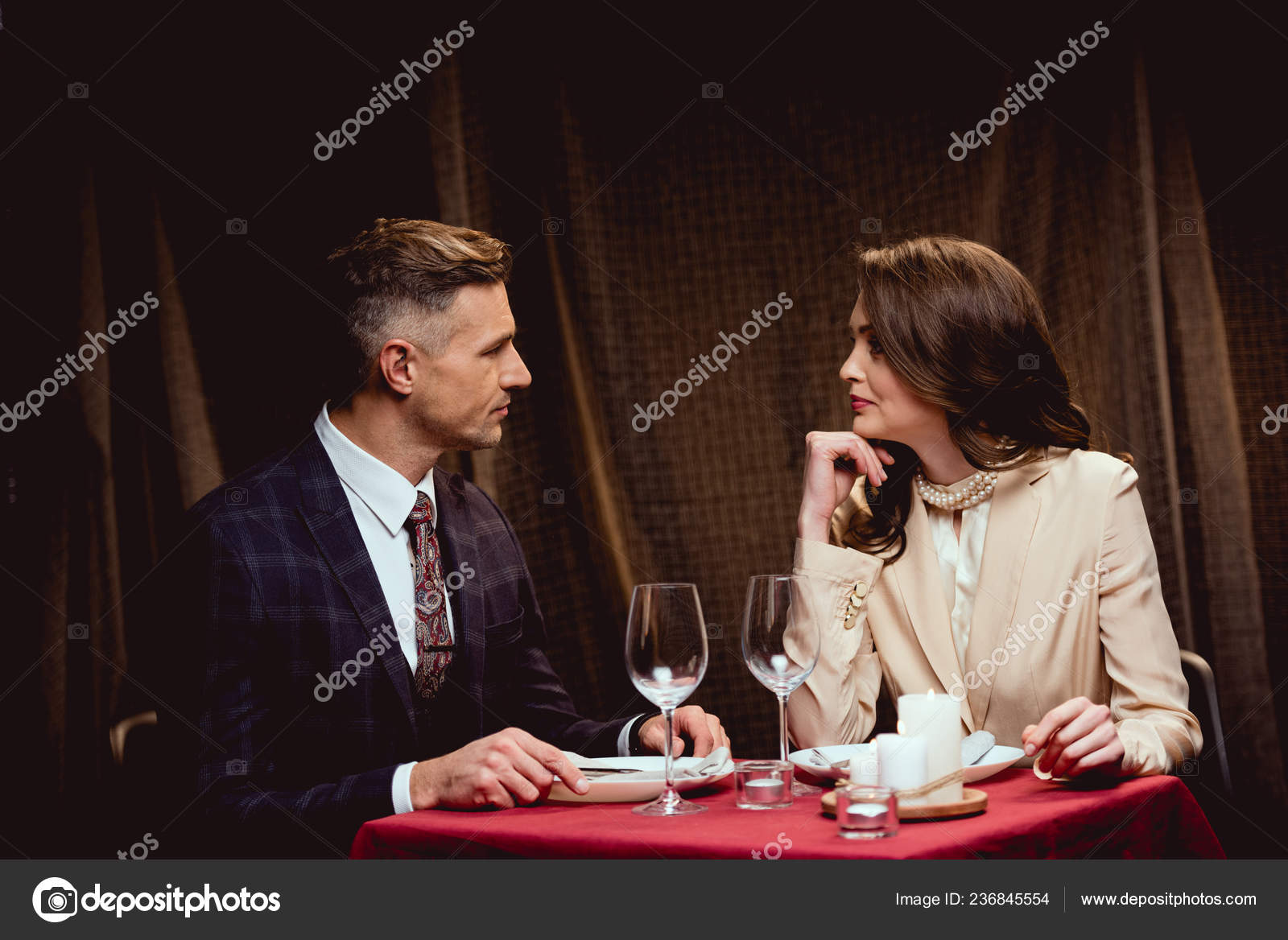 Romantic Couple Sitting At A Table For Two