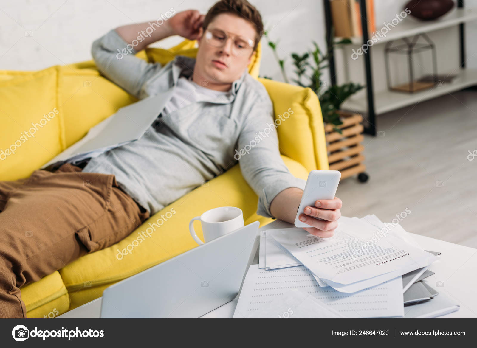 Selective Focus Laptop Man Using Smartphone Lying Sofa Background ...