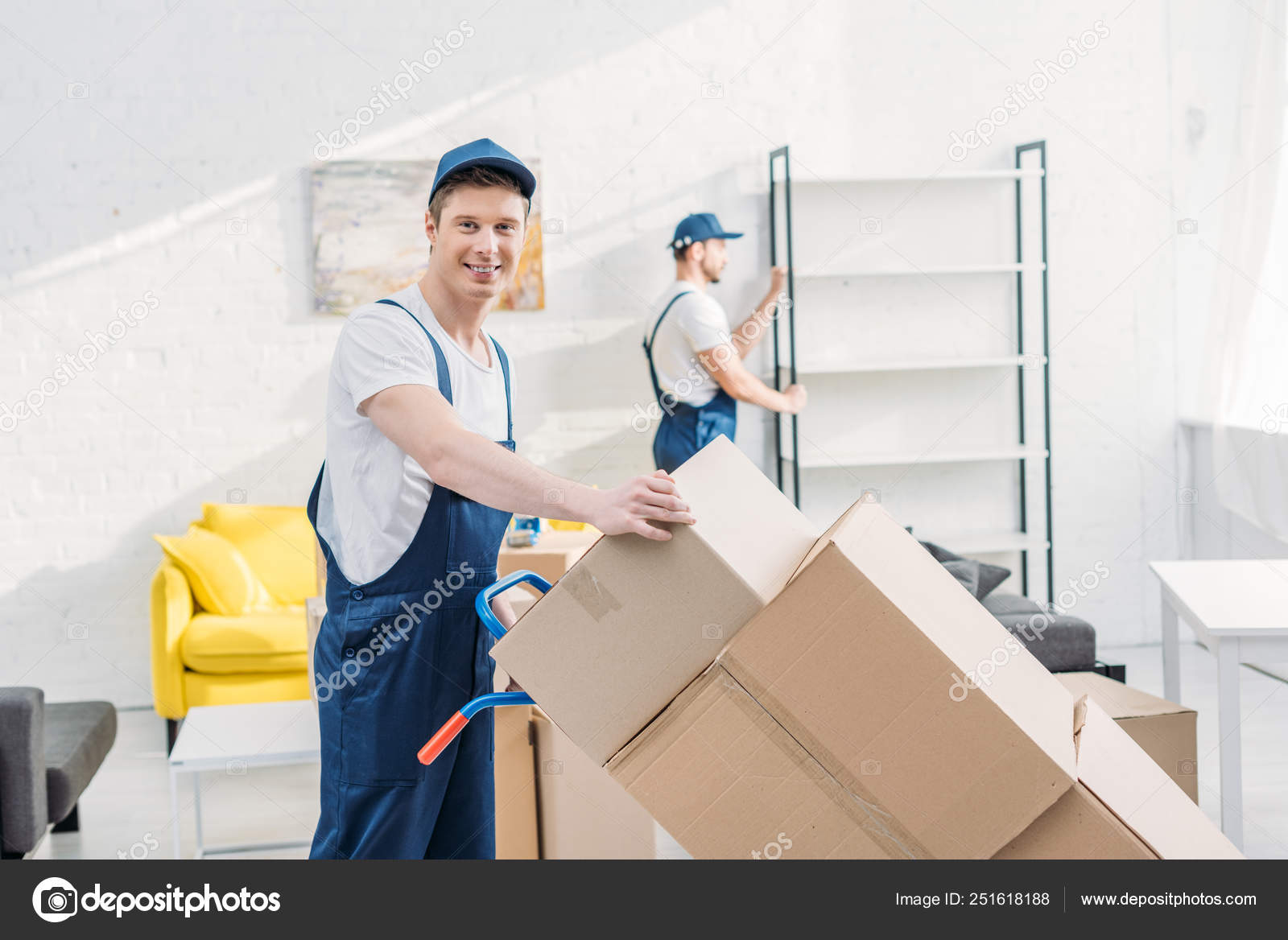 Two Movers Uniform Transporting Cardboard Boxes Furniture Apartment ...
