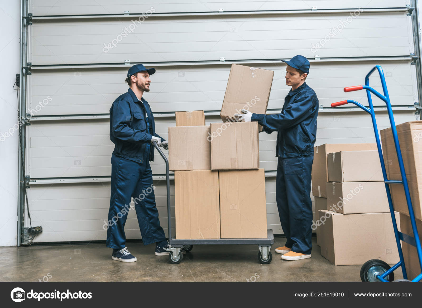 Two Movers Uniform Transporting Cardboard Boxes Hand Truck Warehouse ...