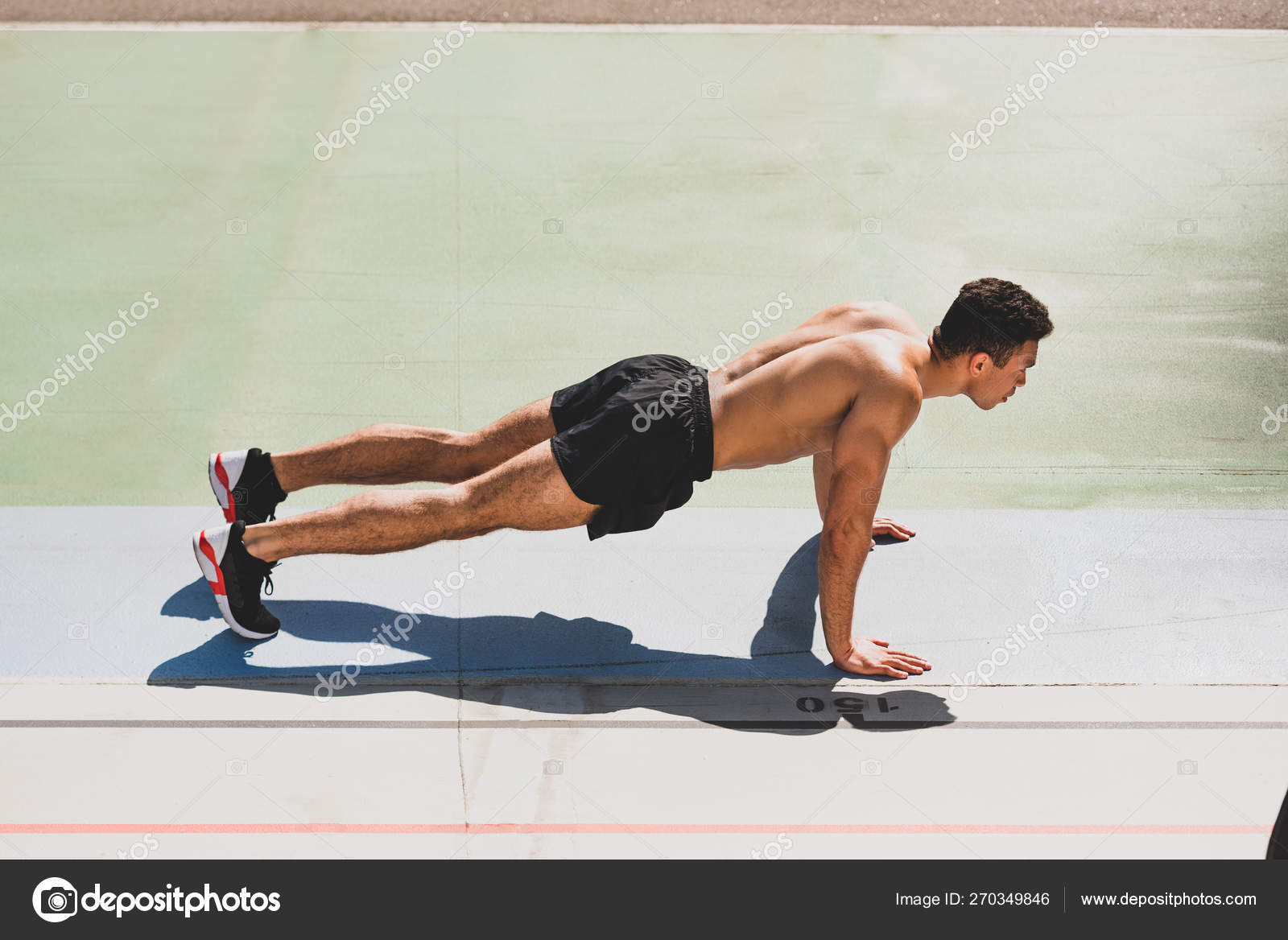 Mixed Race Sportsman Standing Plank Stadium Stock Photo by ...