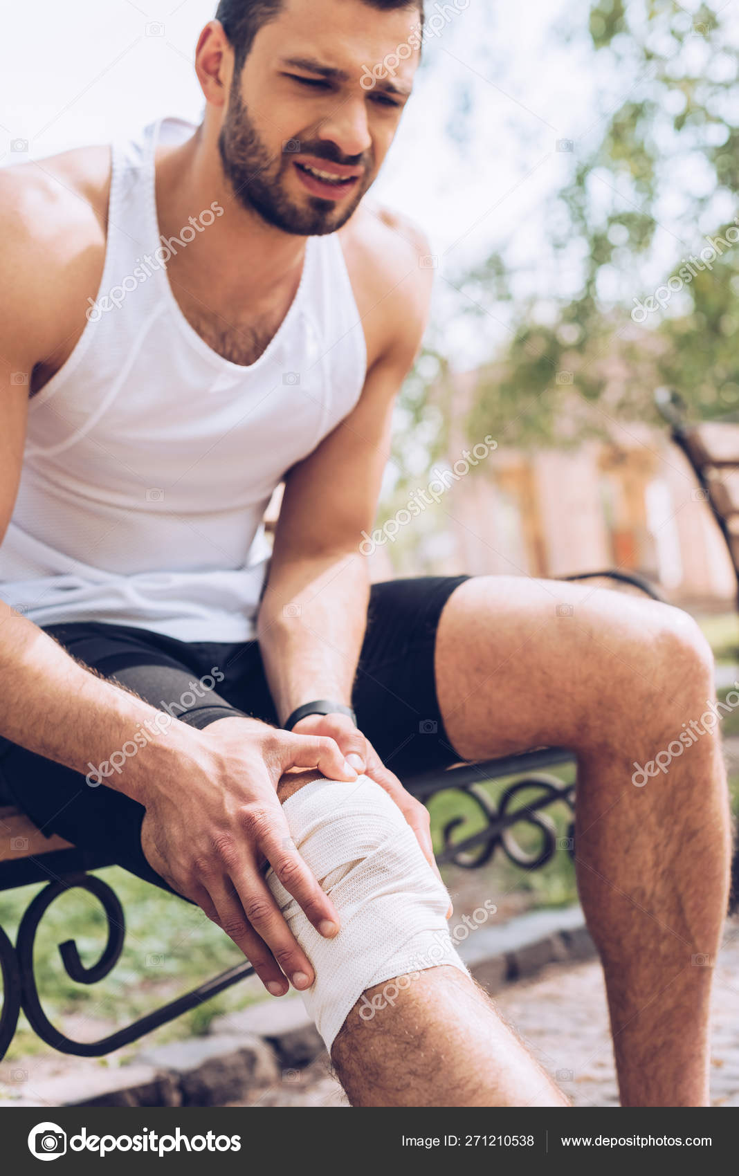 Upset Sportsman Sitting Bench Touching Elastic Bandage Injured Knee ...
