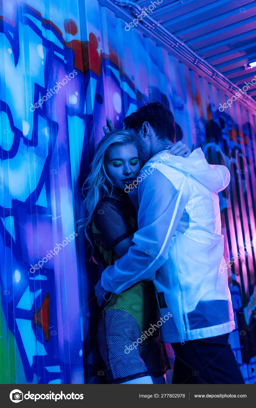 Attractive Blonde Woman Hugging Man Wall Stock Photo by ©VitalikRadko ...