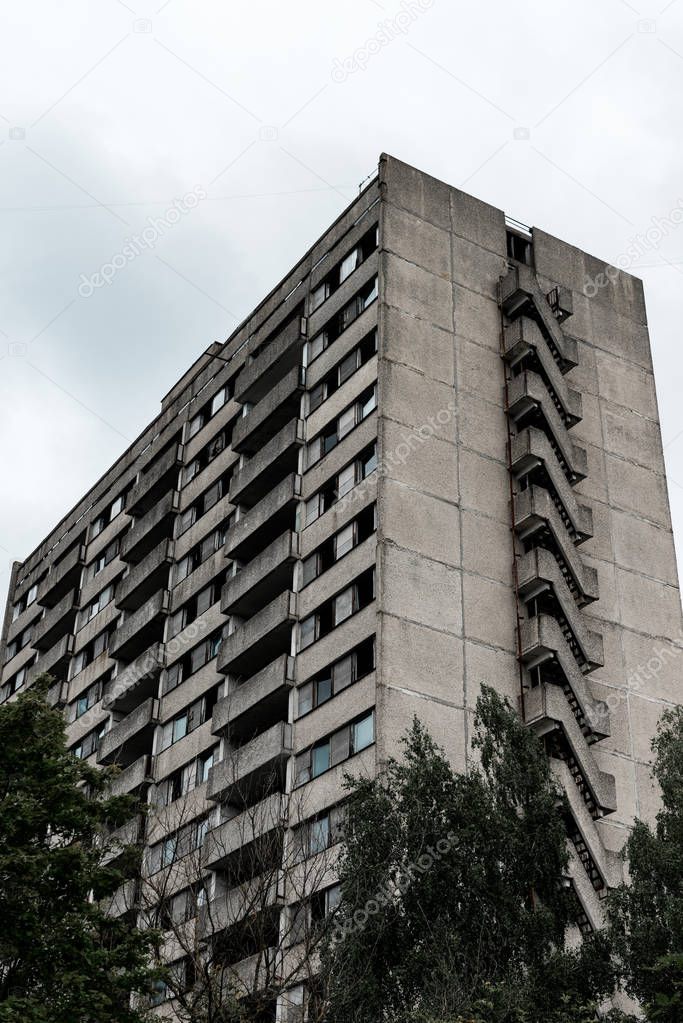 árboles verdes cerca de la construcción contra el cielo con nubes en ...