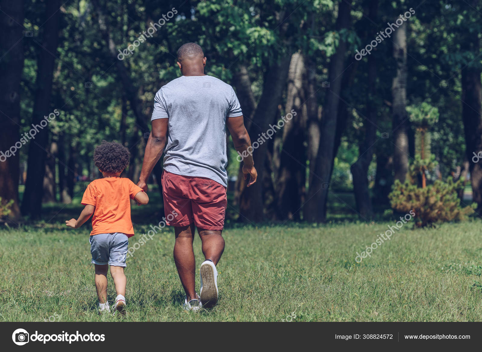 Back View African American Father Son Holding Hands While Walking