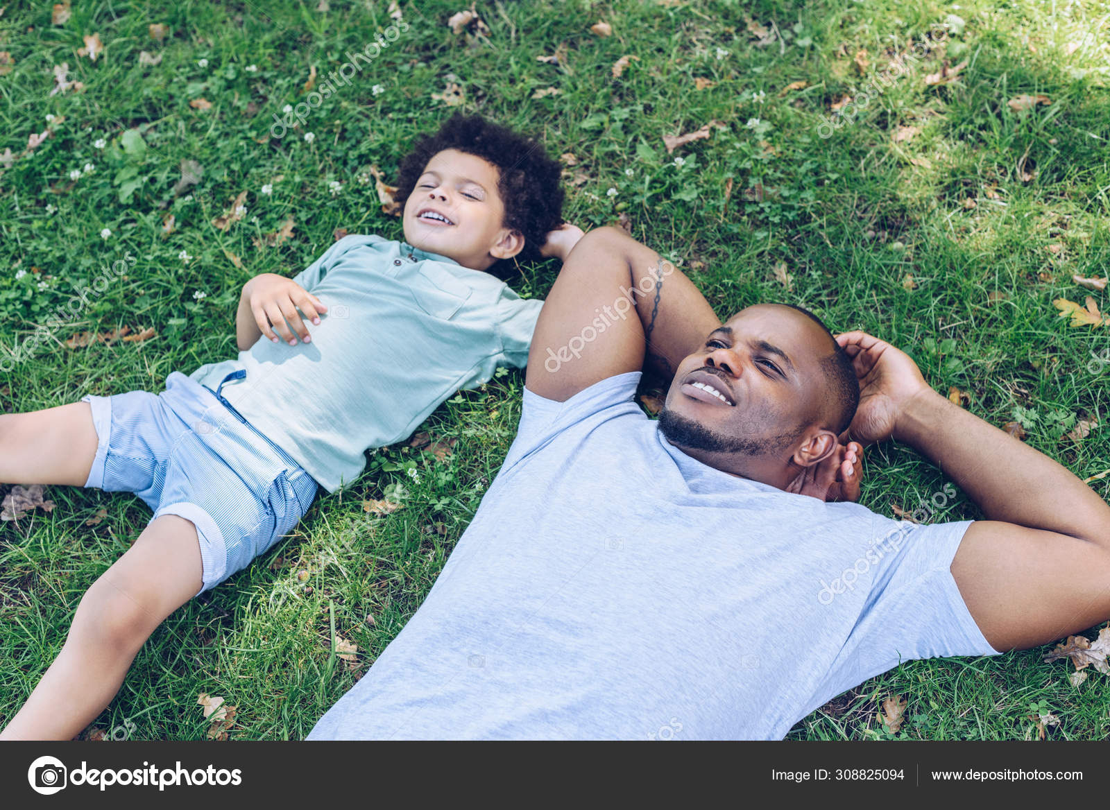 Smiling African American Father Son Lying Lawn While Resting Park Stock ...