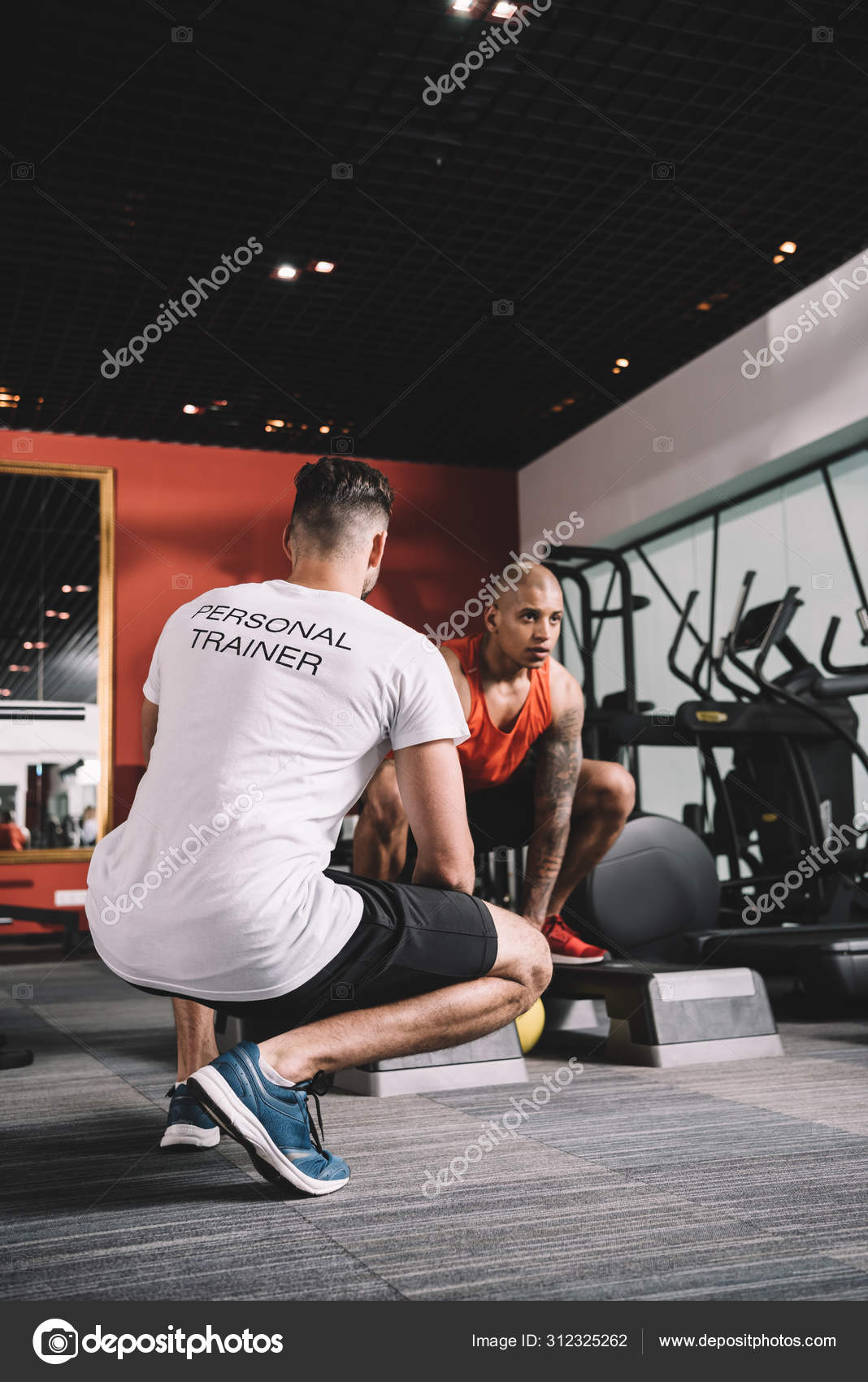 Back View Personal Trainer Supervising African American Athlete Lifting ...