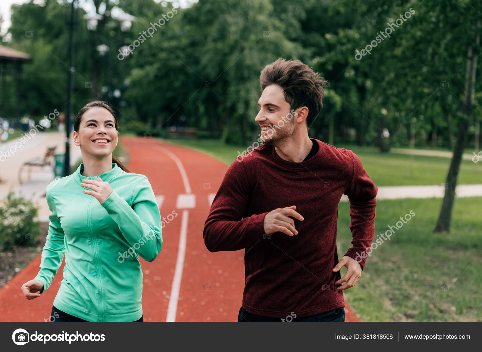 Smiling Man Looking Positive Girlfriend While Jogging Park Stock Photo ...