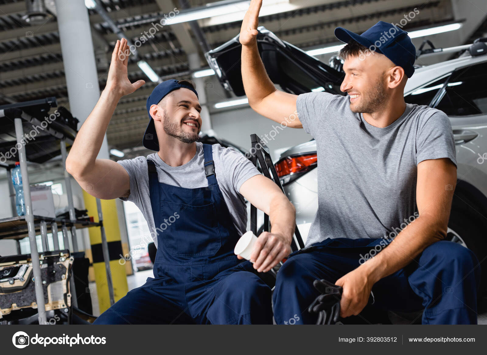 Happy Auto Mechanic Sitting Giving High Five Colleague Service Station ...