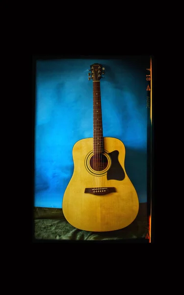 Acoustic guitar on a blue background - Stock Image - Everypixel