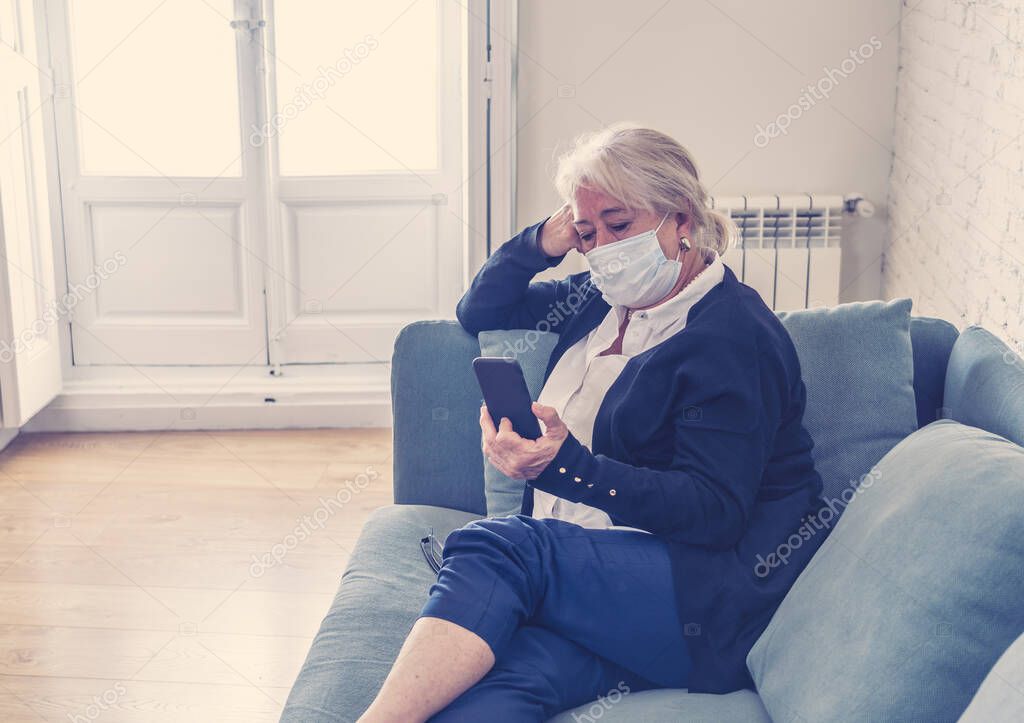 Mujer viuda mayor deprimida y solitaria con máscara protectora llorando ...