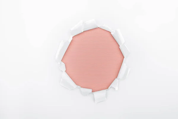 ripped hole in white textured paper on red striped background - Stock ...