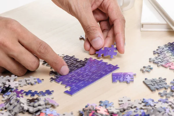 Putting together puzzle Stock Photos, Royalty Free Putting together ...