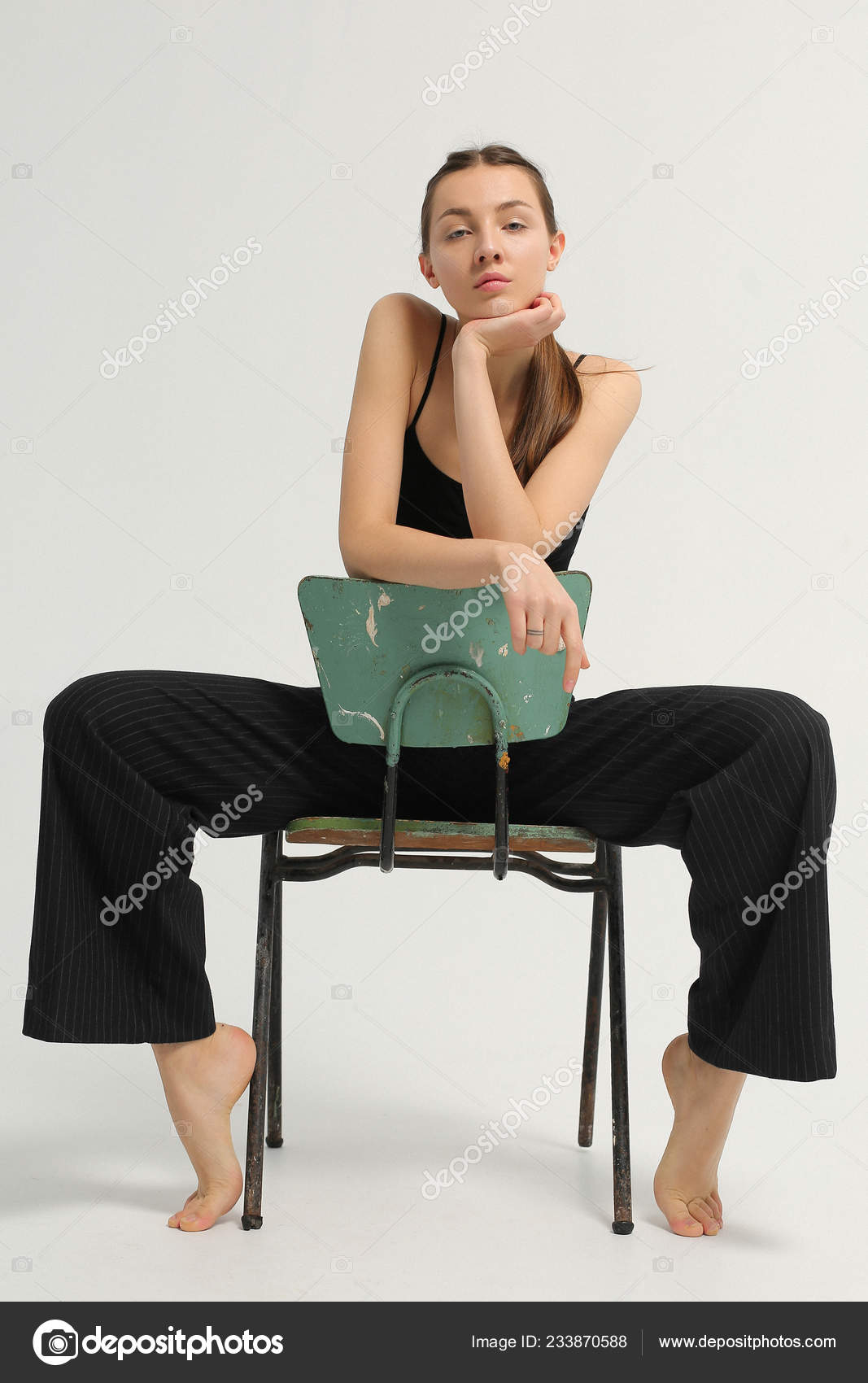Woman Sitting On Chair Legs Open