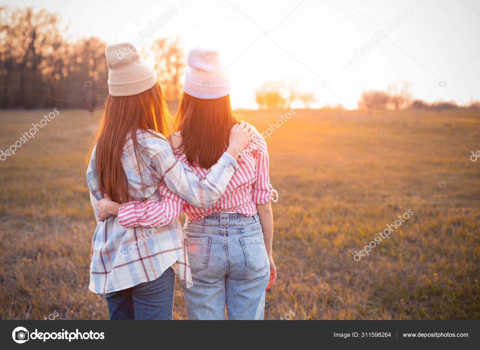 Two Best Friends Holding Hands In The Sunset