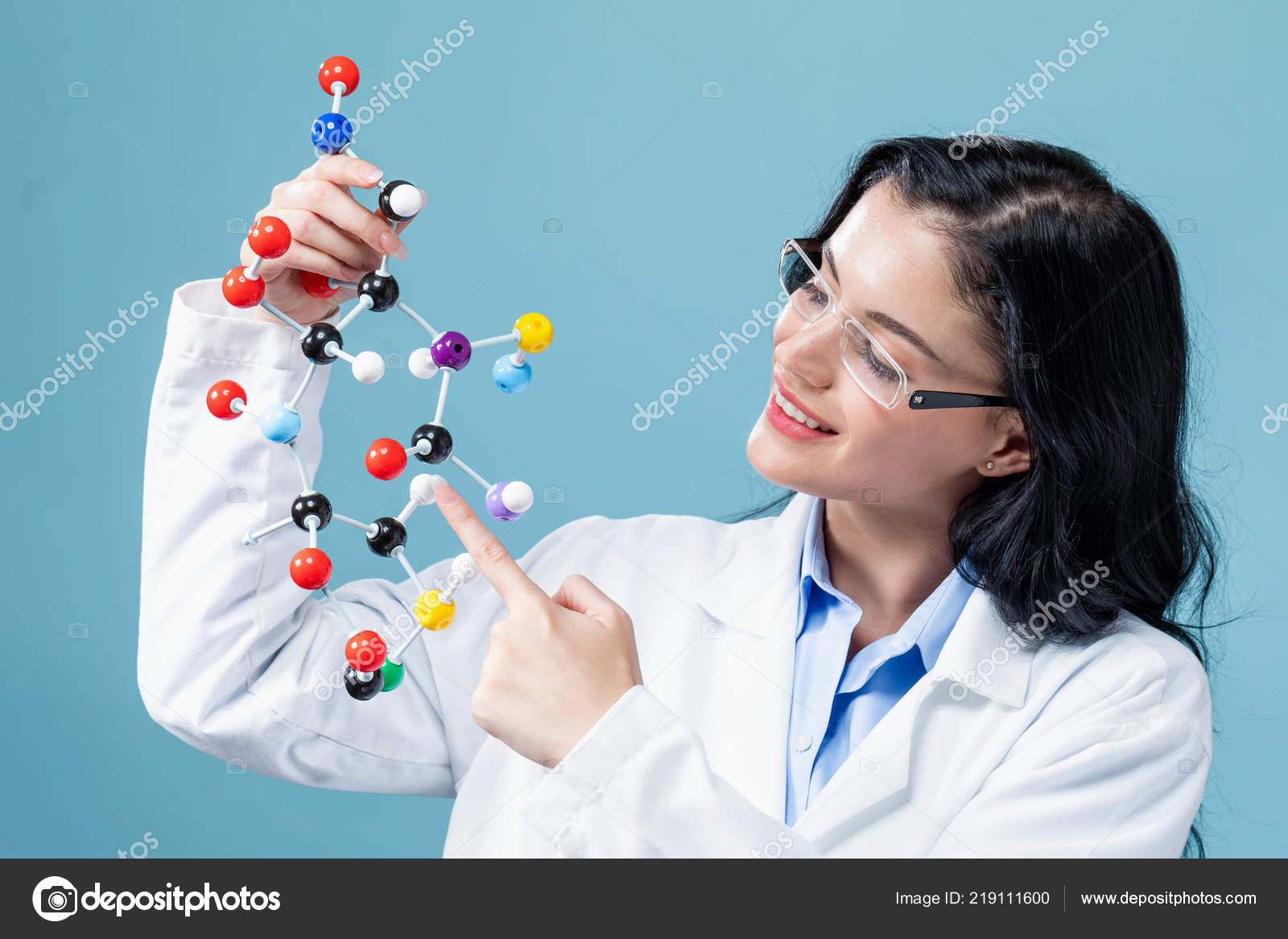 Female scientist with molecule model Stock Photo by ©Melpomene 219111600