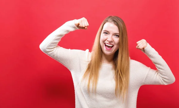 Powerful young woman in a success pose — Stock Photo © Melpomene #176601924