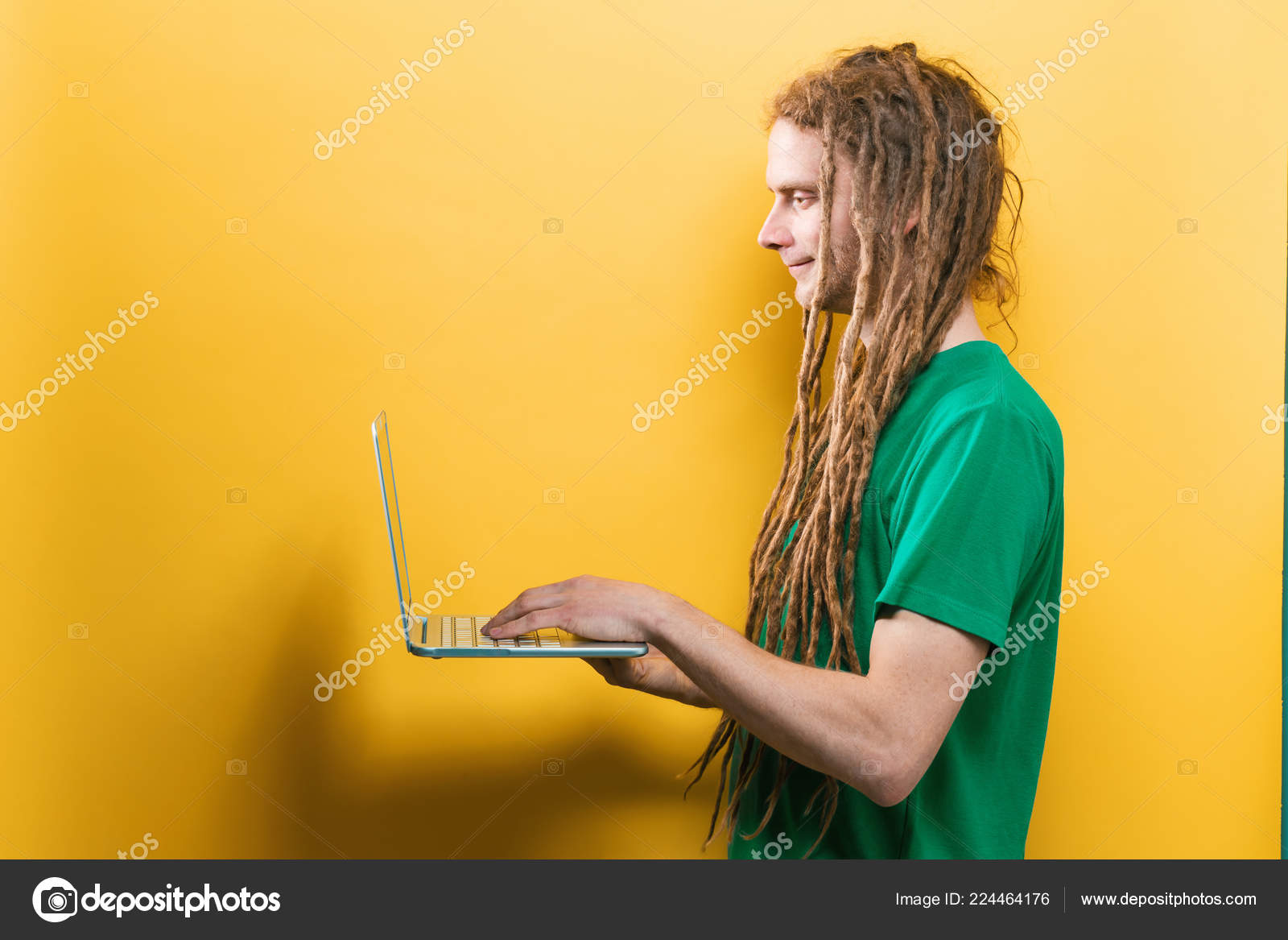 Happy man using a laptop on a solid background — Stock Photo ...
