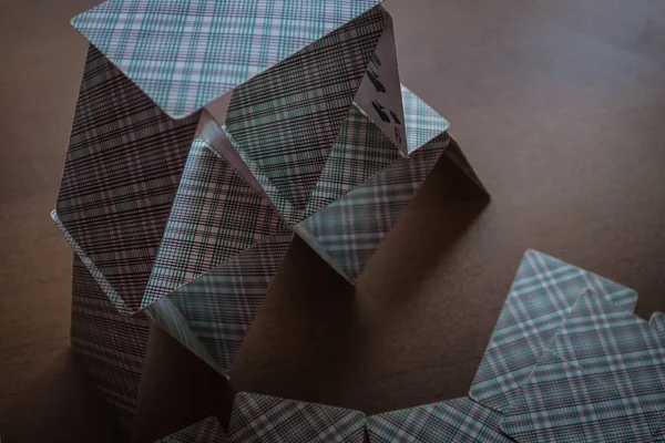 Shaky construction of playing cards, fragile, unreliable house of cards ...