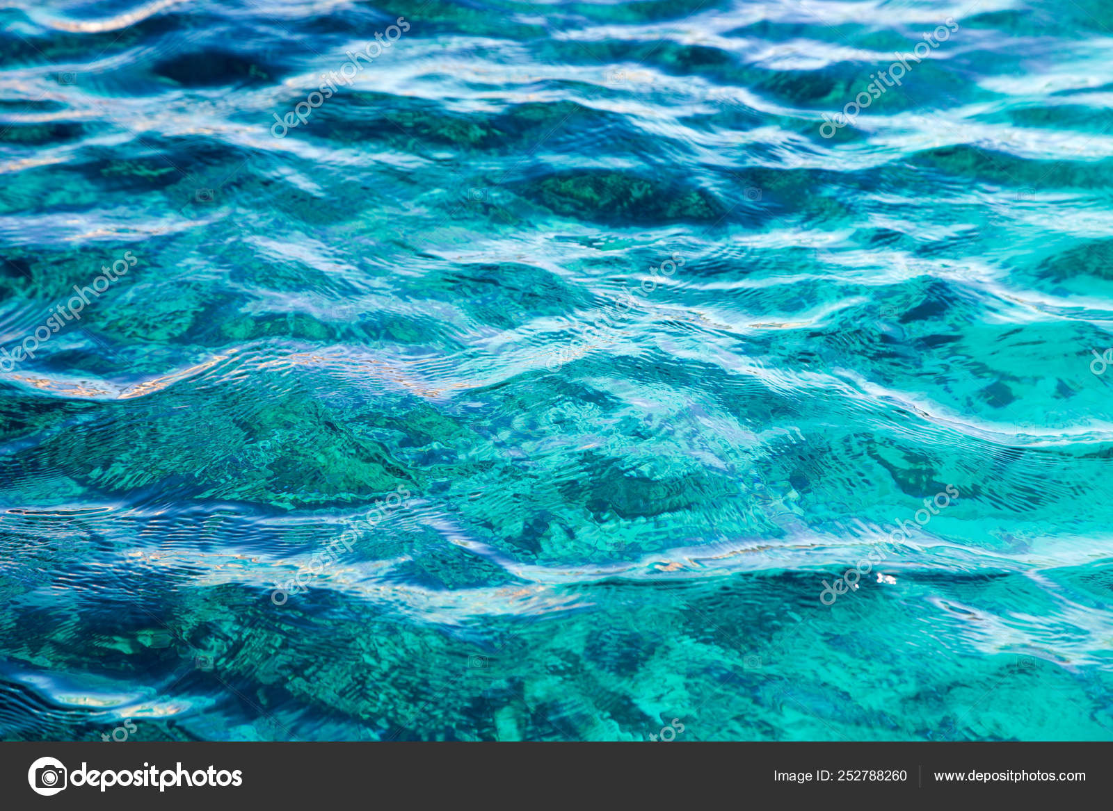 Coral reef is visible through the clear blue water. Beautiful blue sea ...